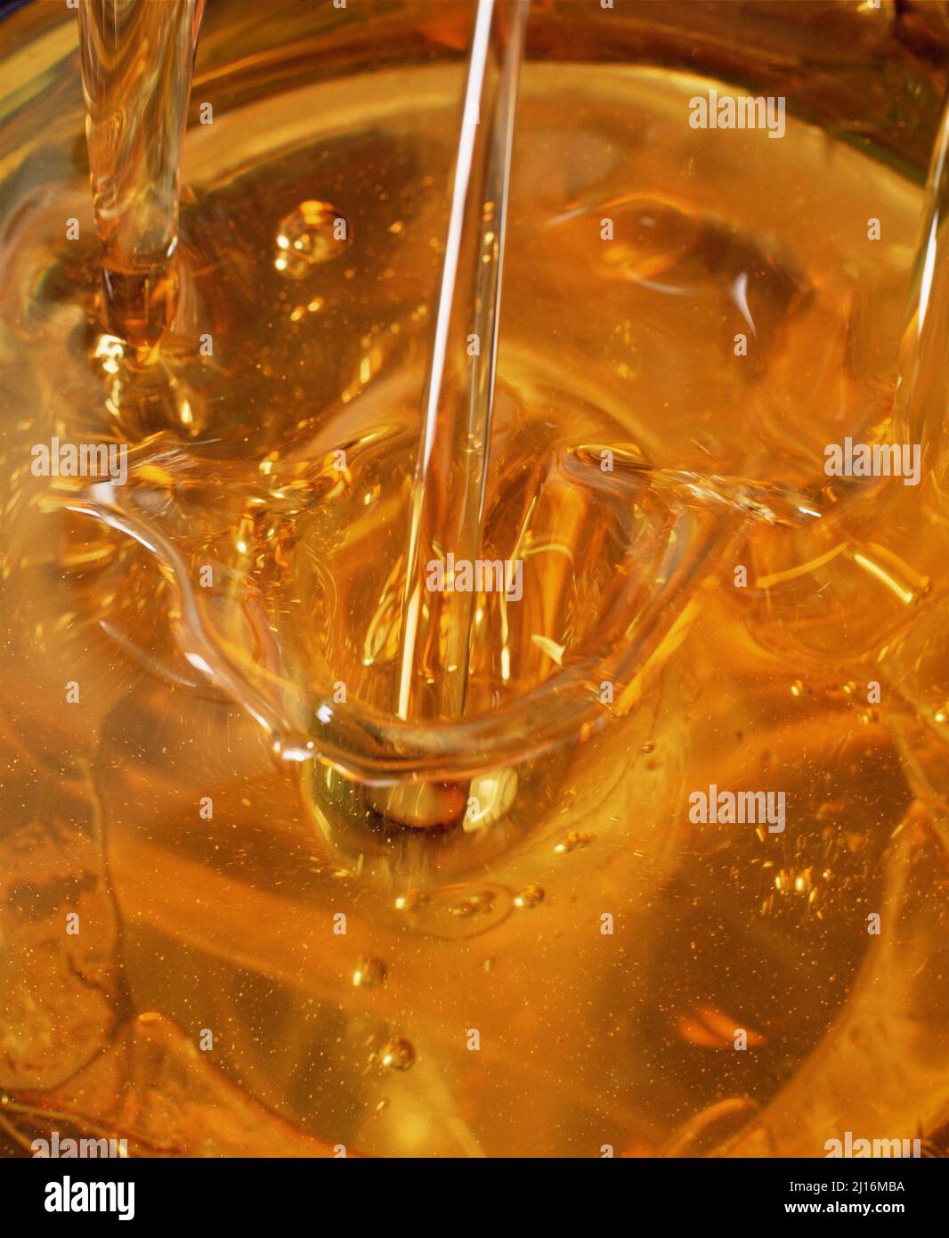 pure, clear sunflower oil being poured into into a glas container Stock ...