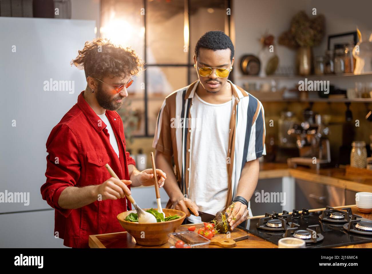 Two friends cooking together home hi-res stock photography and images ...
