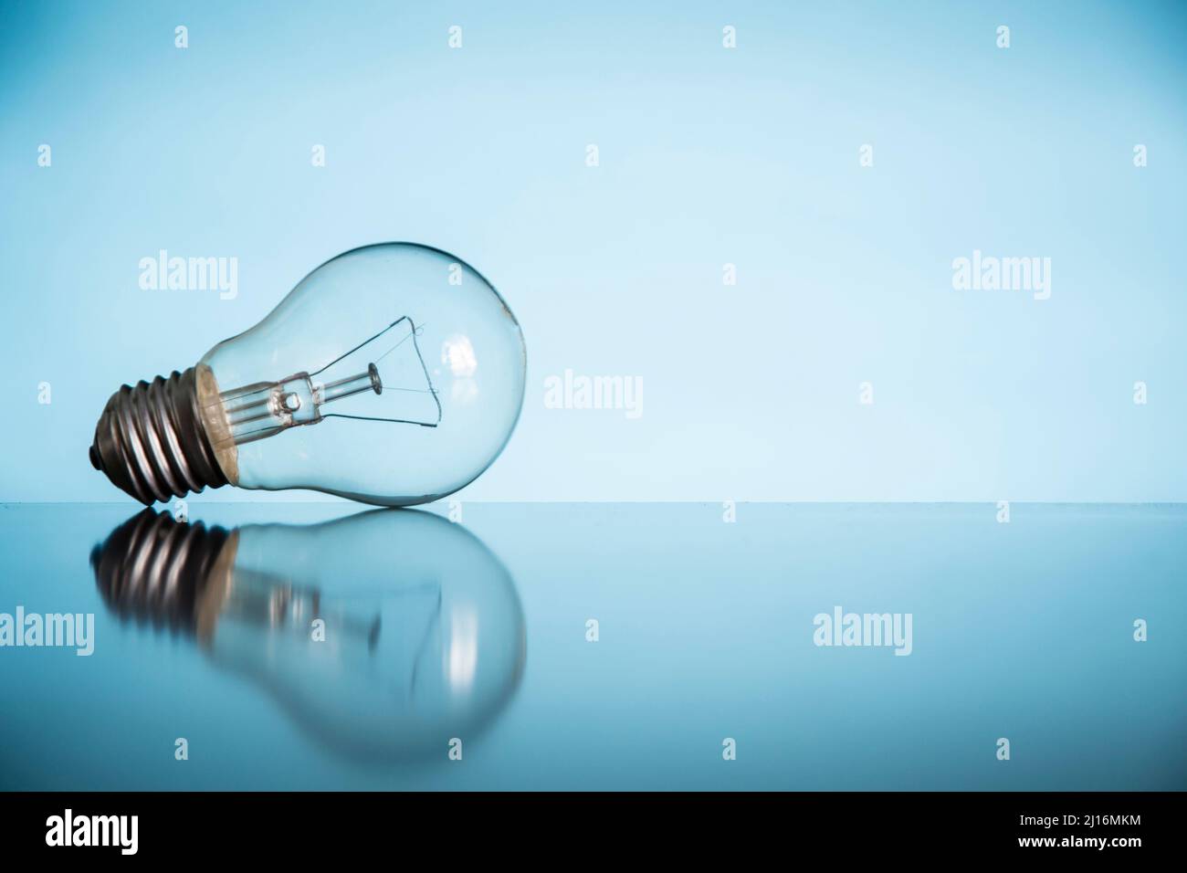 light bulb and blue background Stock Photo - Alamy