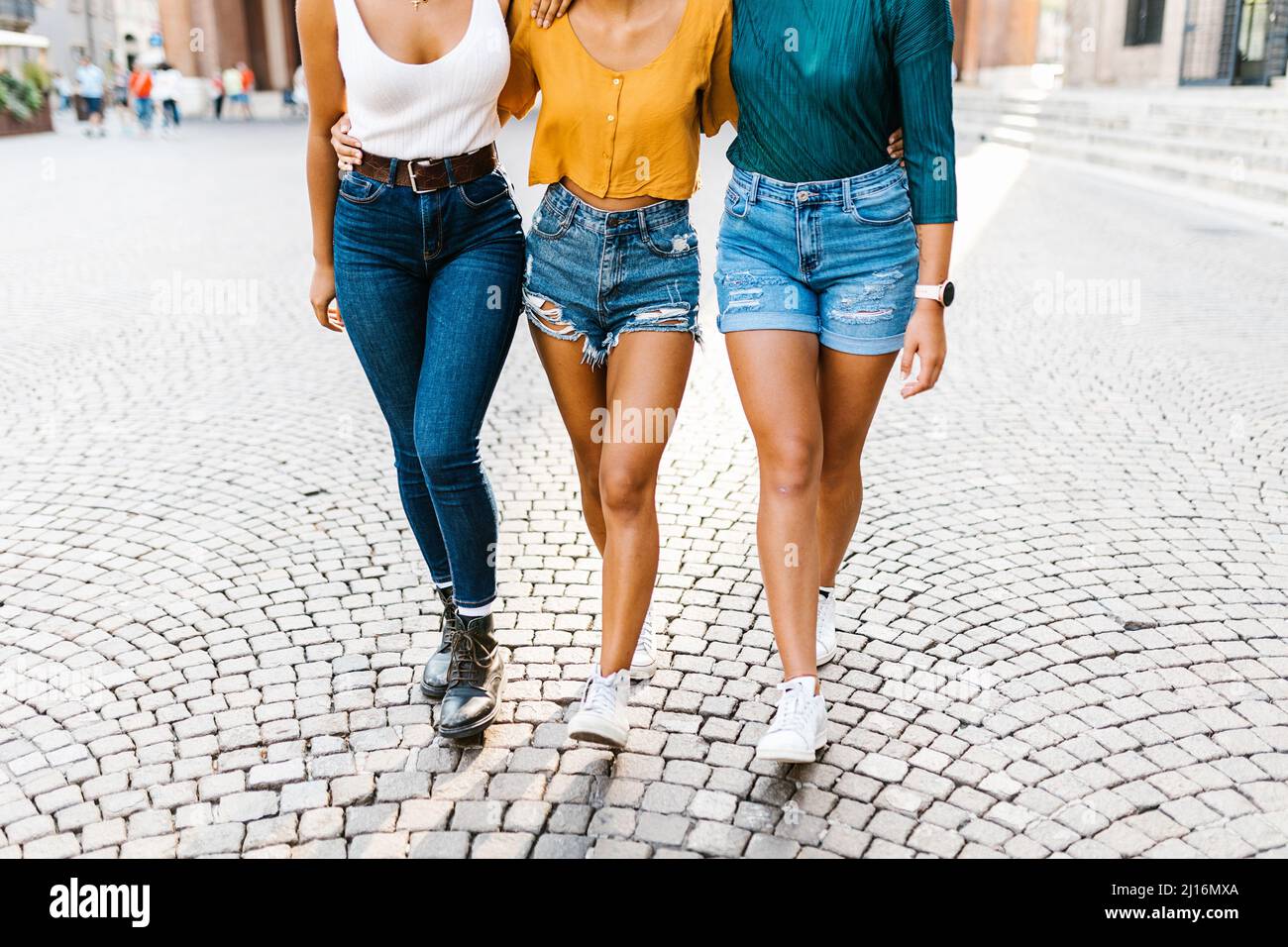 Besties spending weekend at the urban settings while walking on street ...