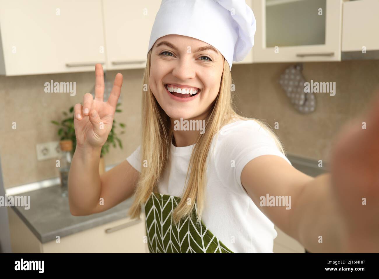Young attractive chef woman doing selfie in kitchen room Stock Photo ...