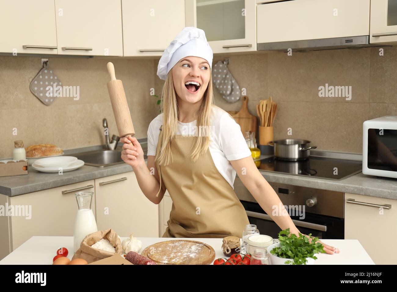 Concept of cooking with young attractive woman in kitchen room Stock ...