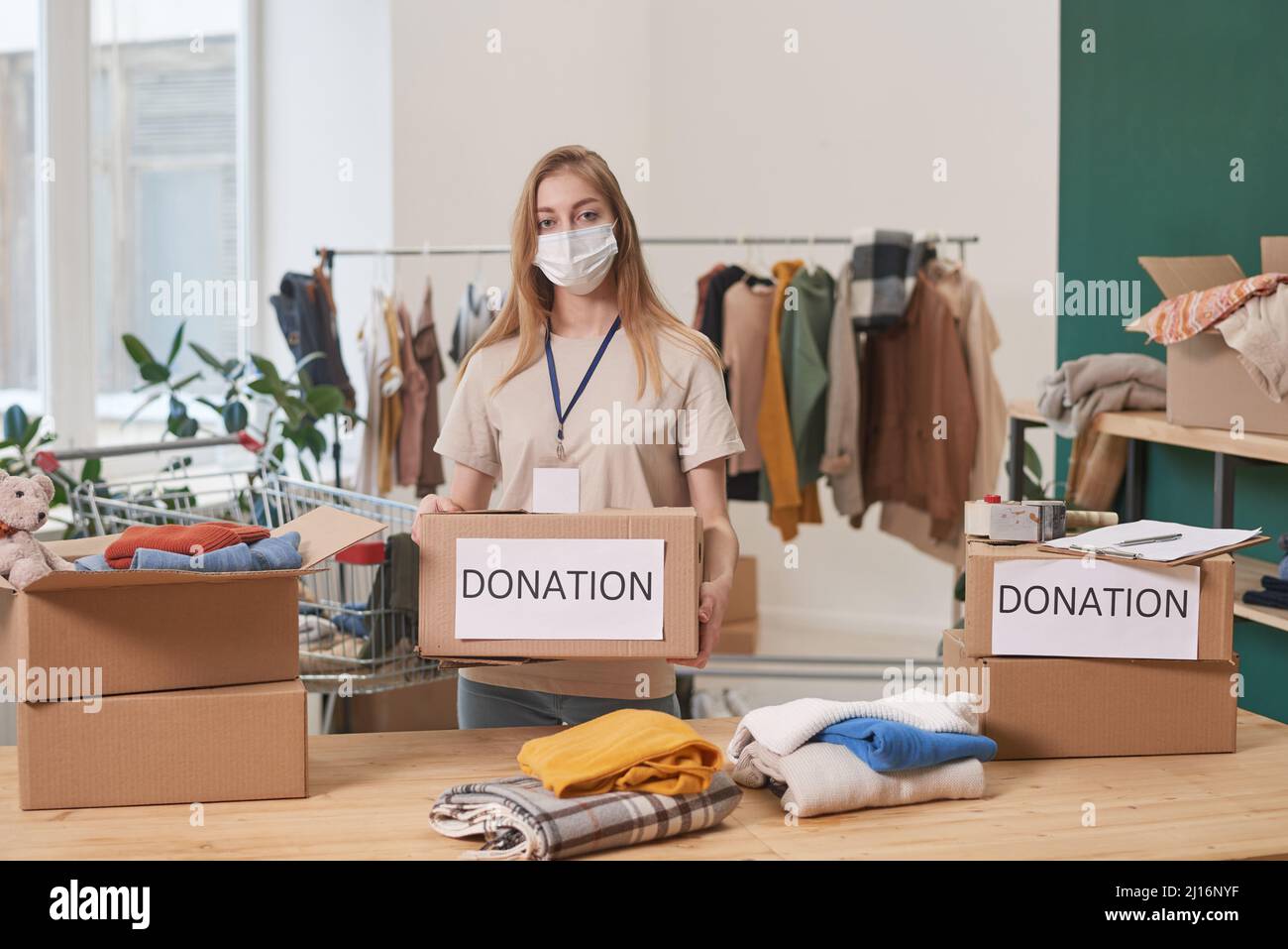 Portrait of unrecognizable young woman wearing protective mask on face ...