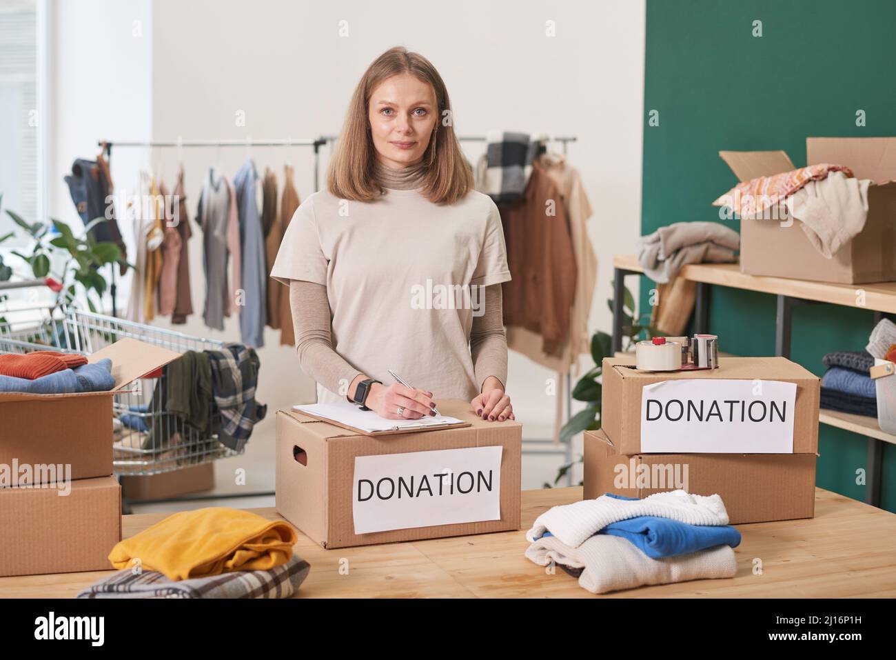 Clothing donation container and person hi-res stock photography and ...