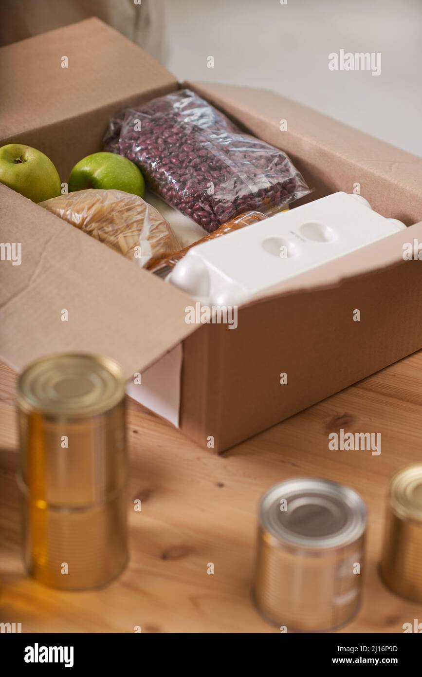 Vertical high angle no people shot of cardboard box full of various ...