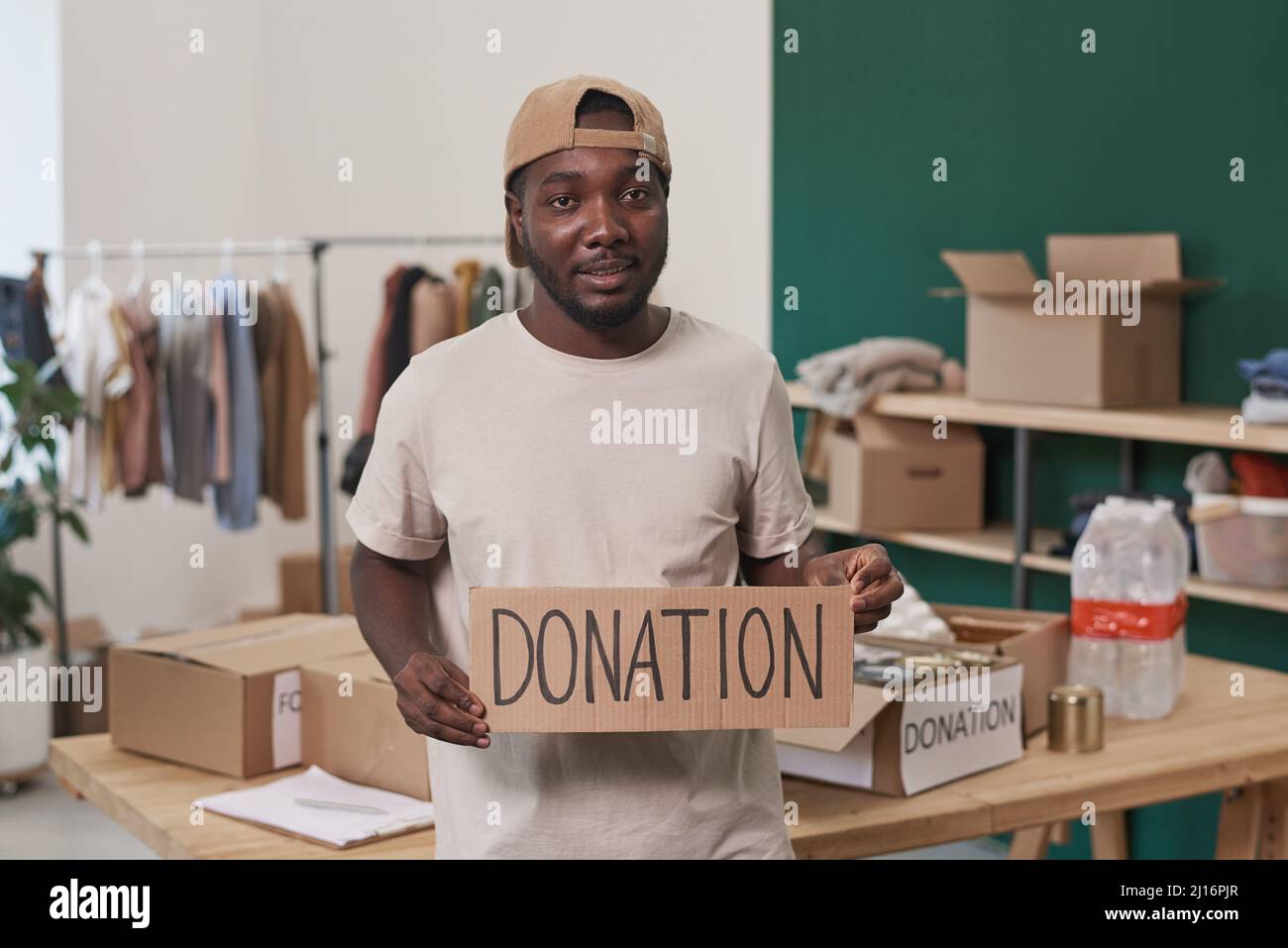 Medium portrait of modern African American man volunteering in charity ...