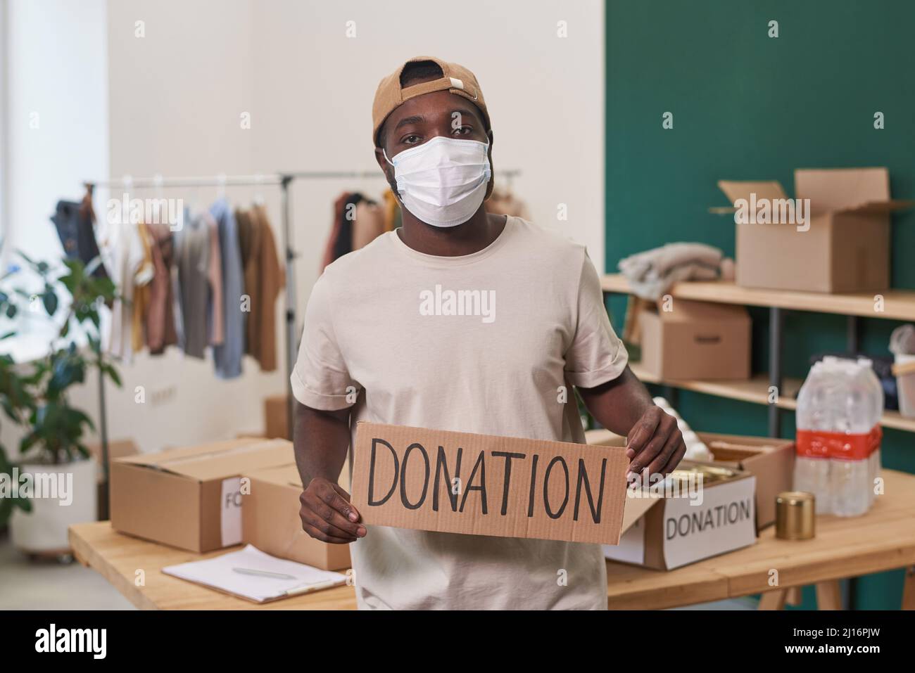 Medium portrait of modern African American man wearing beige T-shirt ...