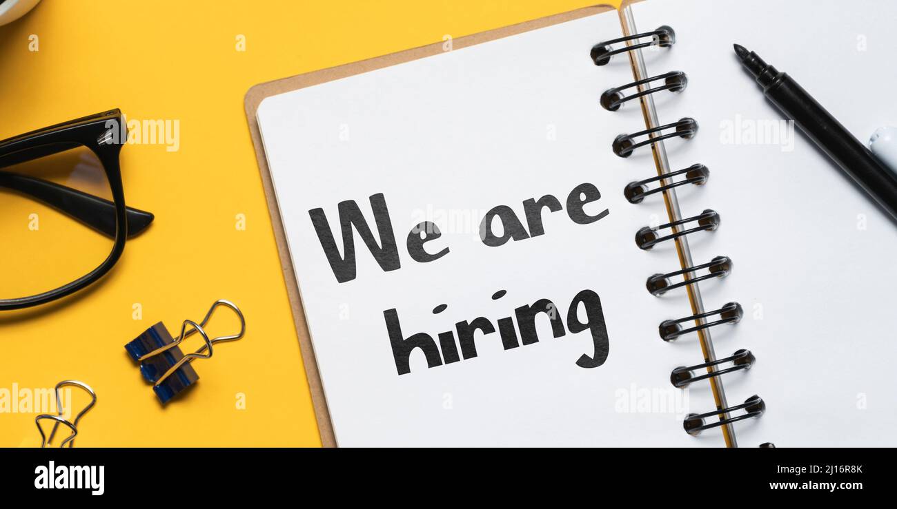 Writing on a notepad with a marker we are hiring Stock Photo - Alamy