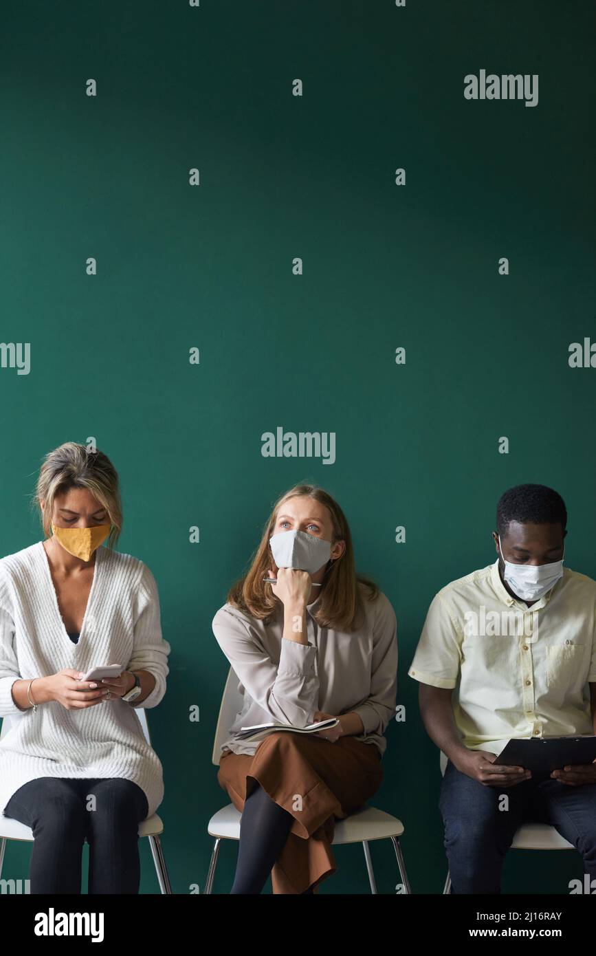 Group of modern multi-ethnic people wearing protective masks waiting ...