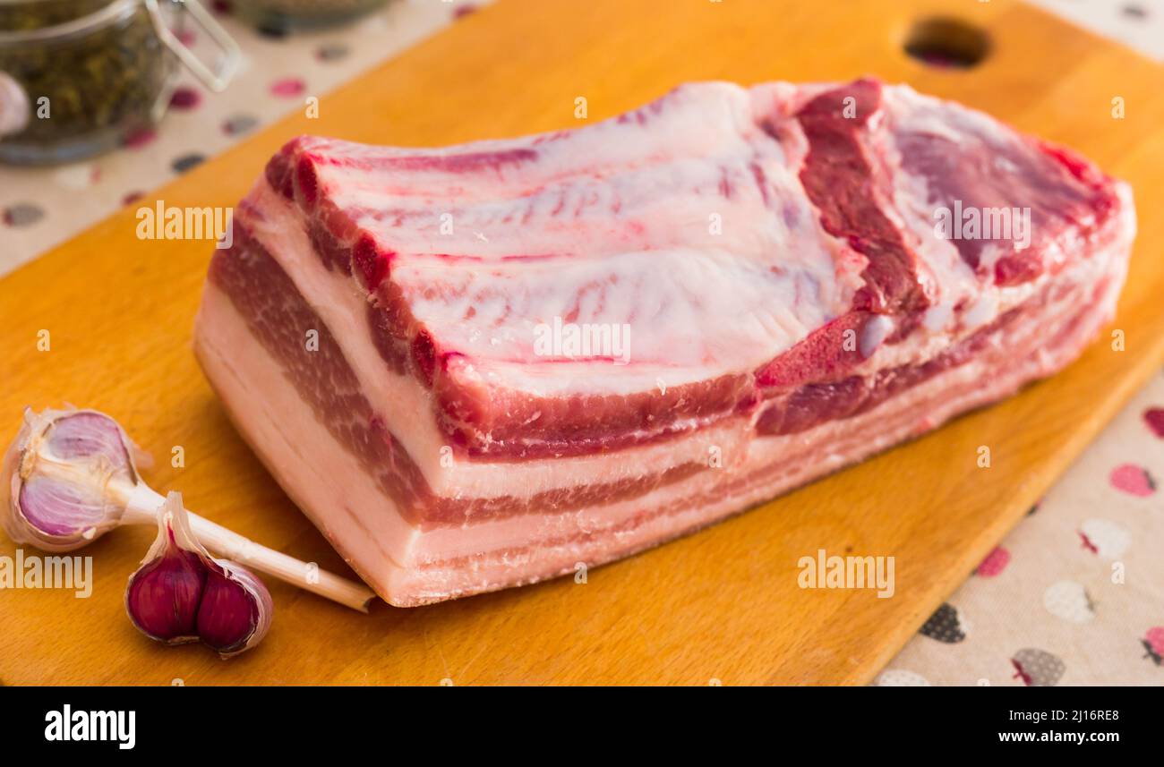 cooking traditional homemade lard with spices. pork belly with layer on ...