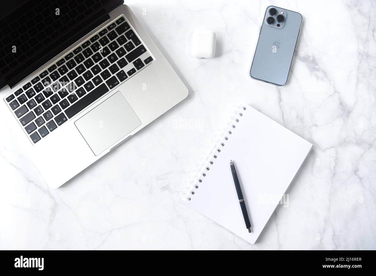 Overhead of laptop computer, mobile phone and notebook Stock Photo - Alamy