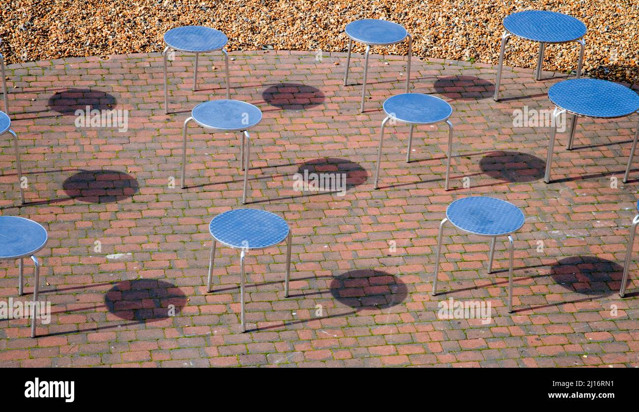 round tables and shadows on brighton seafront Stock Photo - Alamy