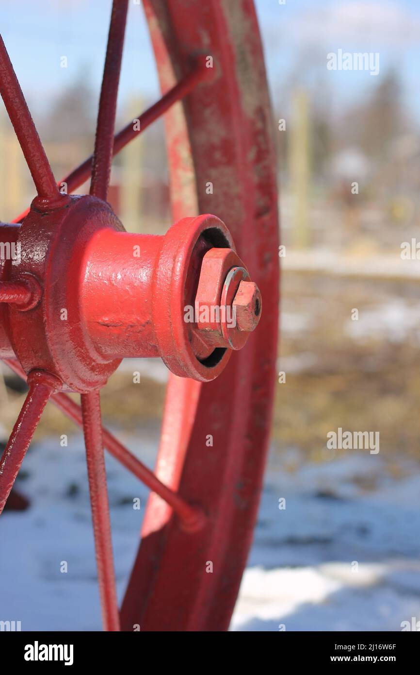 Bright red wagon wheel running on an old vintage farm wagon Stock Photo ...
