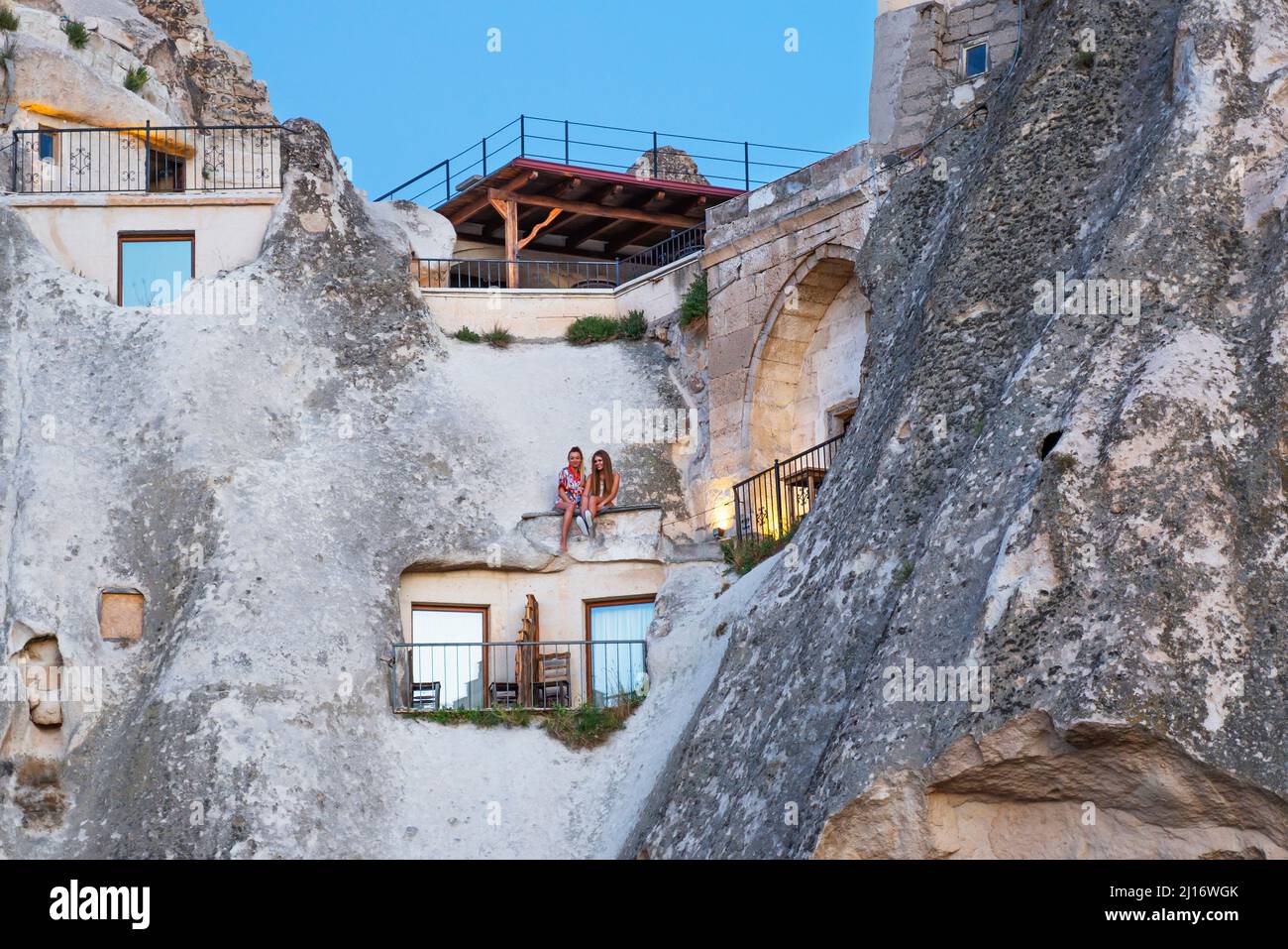 Turkey, Goreme.June 19, 2021. Tourists rest on a steep slope around the ...