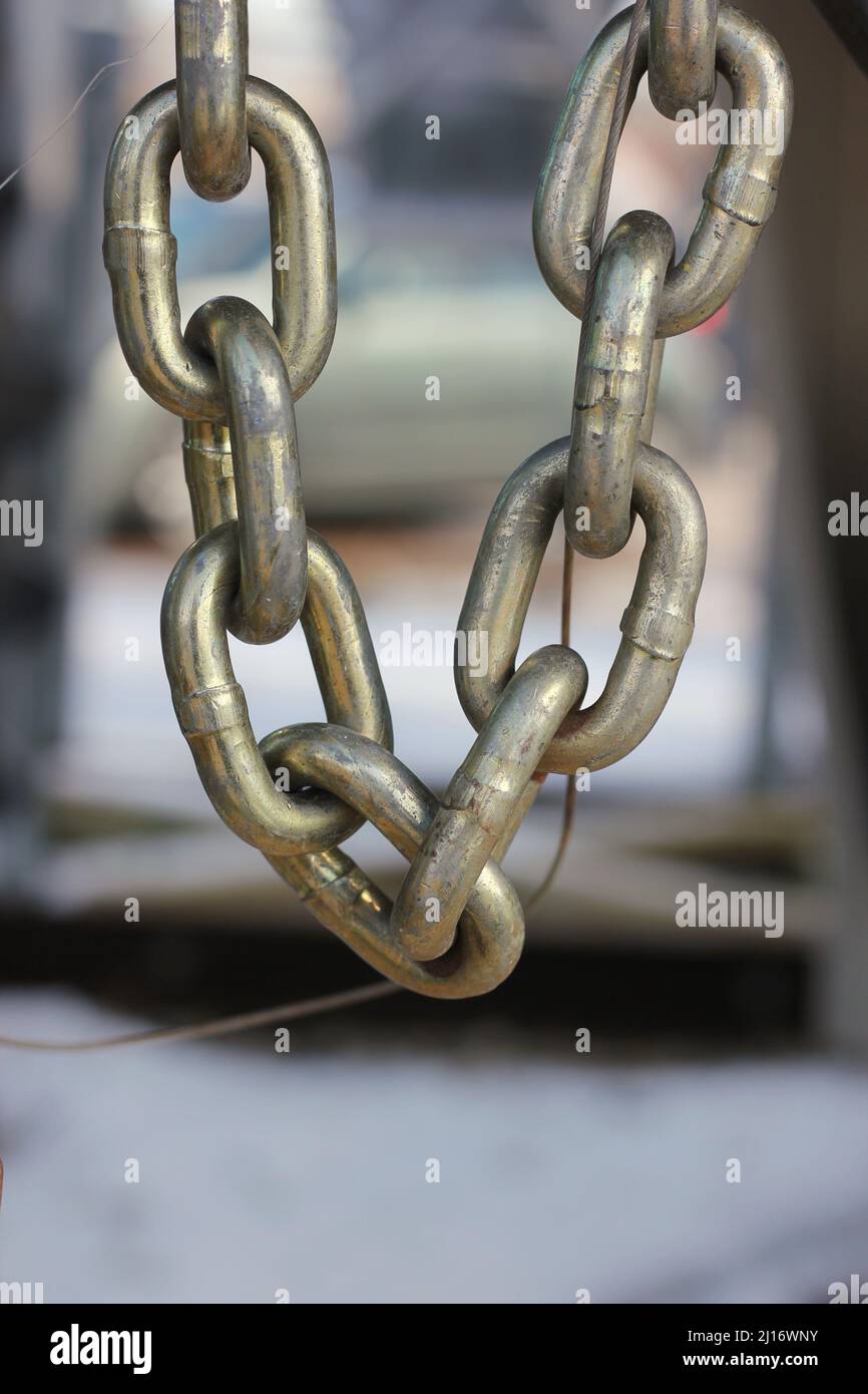 Closeup of a heavy chain with industrial metal links hanging down Stock ...