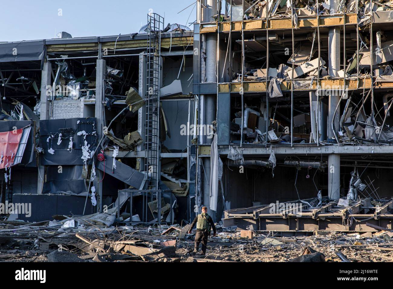 Ukrainian soldier seen patrolling a bomb site during military curfew in ...