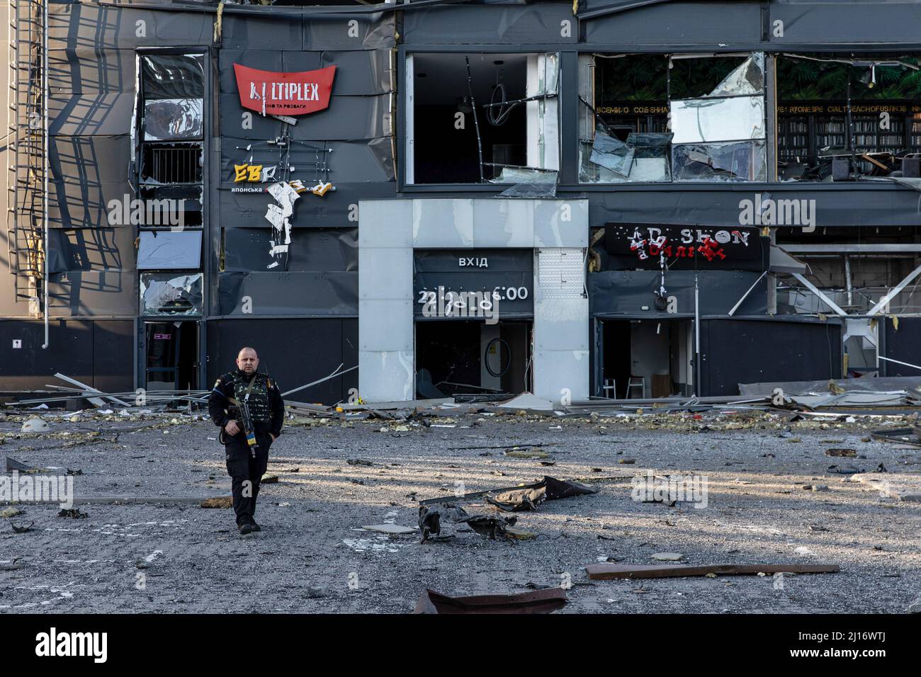 Ukrainian soldier seen patrolling with his rifle at a bomb site during ...