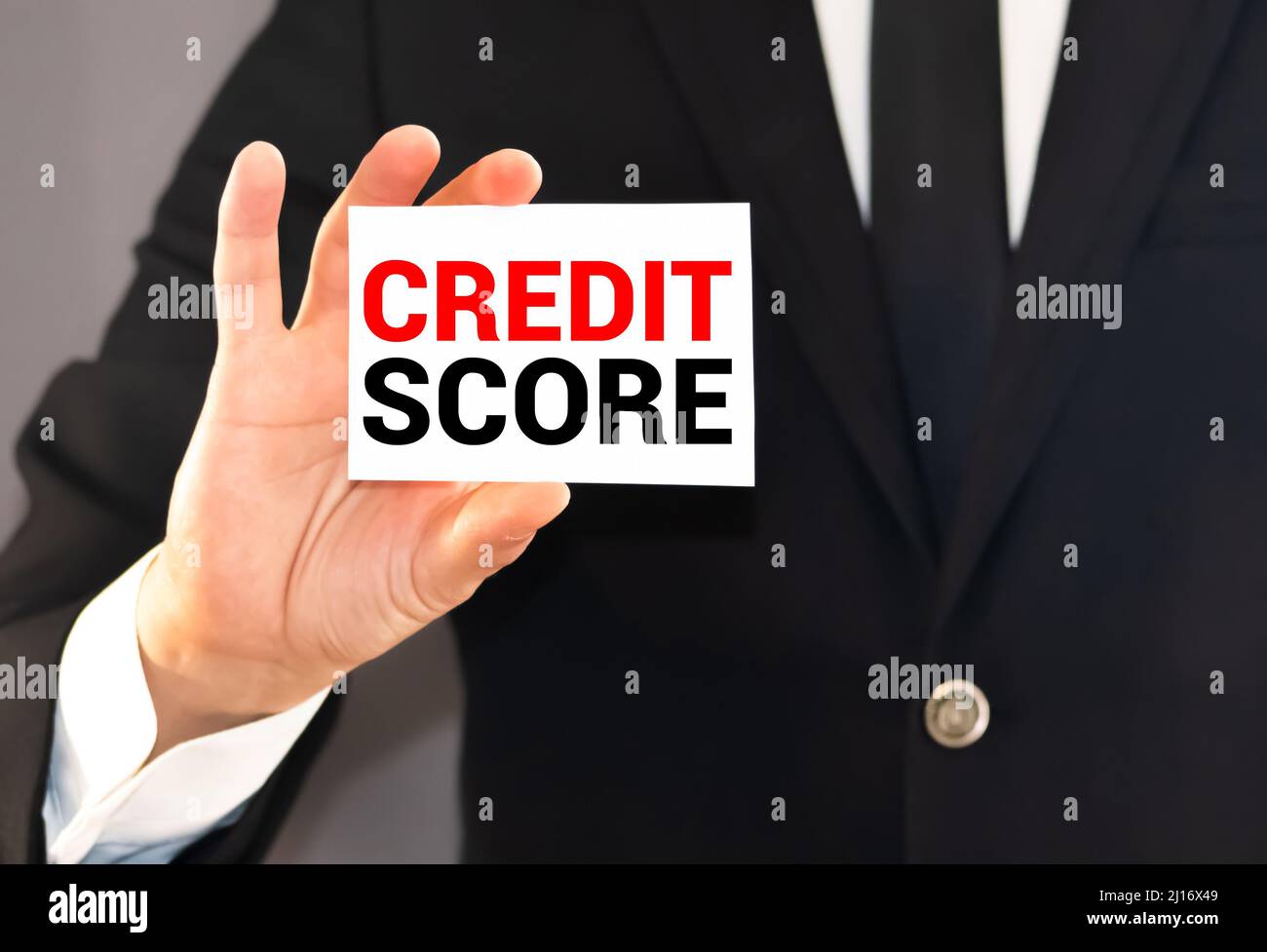 man in suit showing a signboard with the different ranges of the credit ...