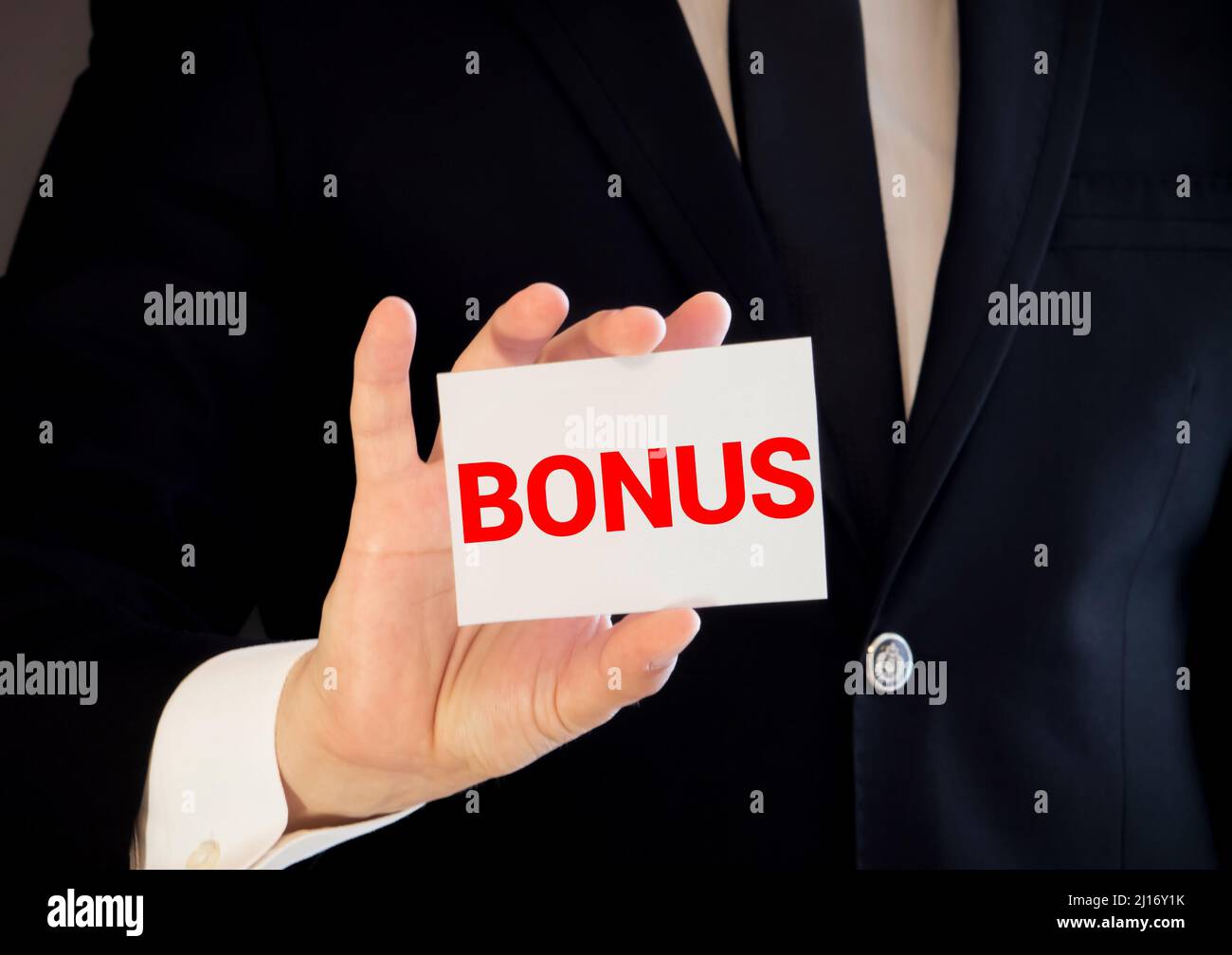 BONUS word on business card held by a man Stock Photo - Alamy