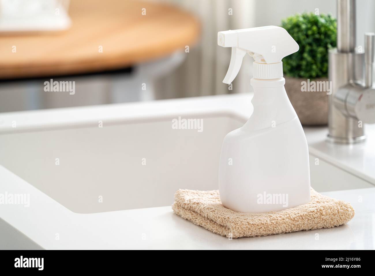 Concept of cleaning product spray bottle and rag in modern kitchen ...