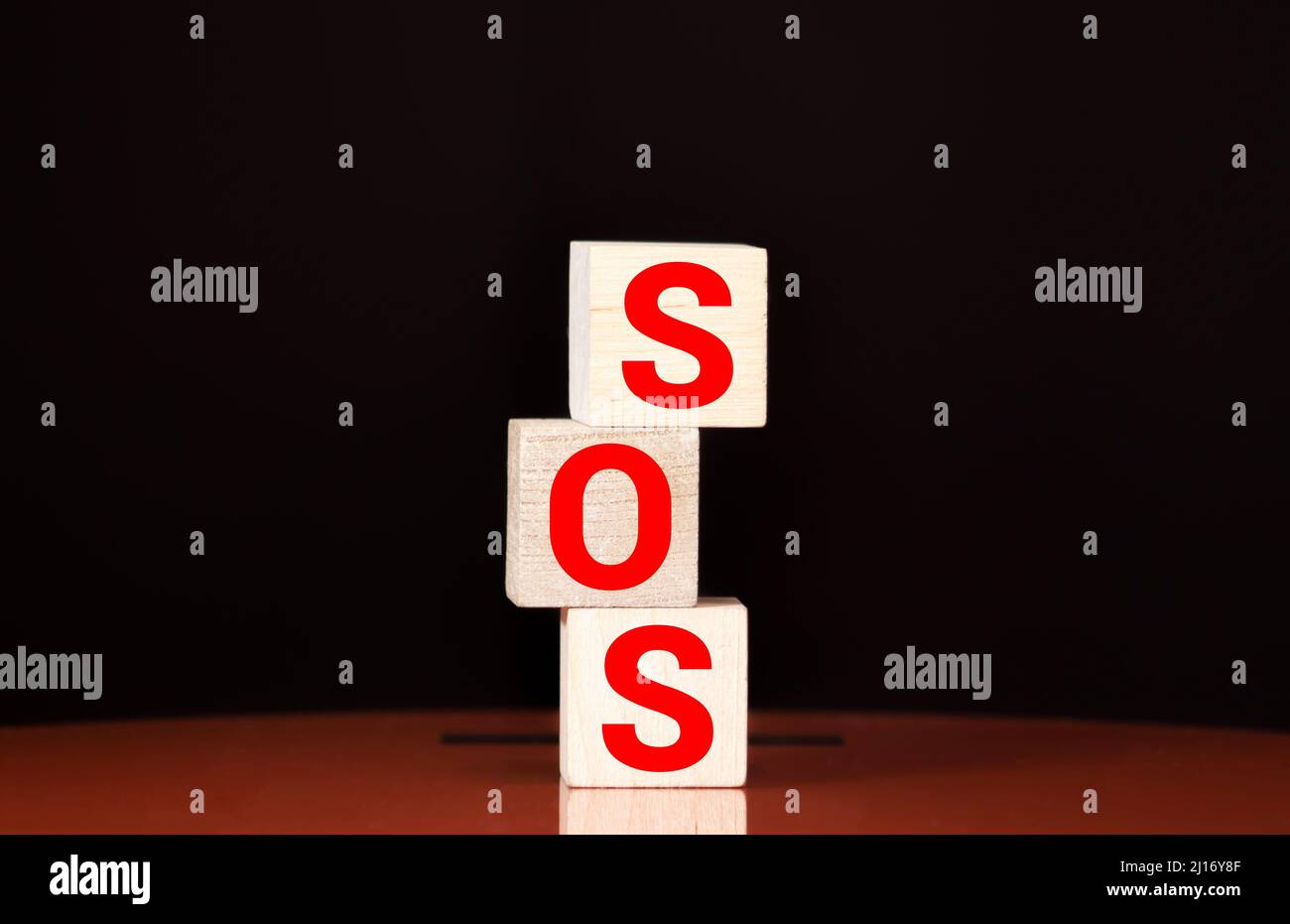 Wooden blocks forming the letters SOS isolated on white background ...