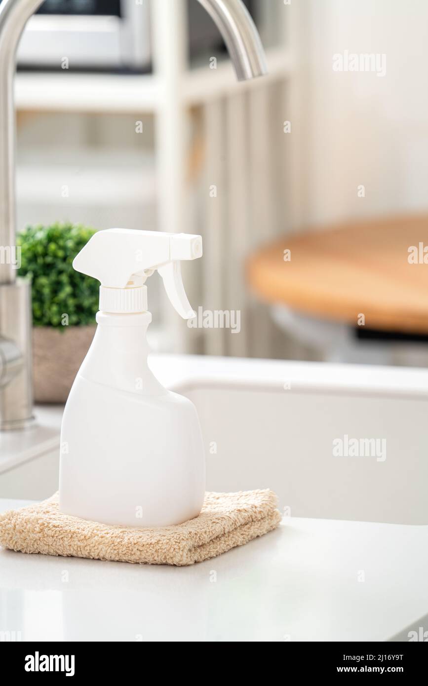 Concept of cleaning product spray bottle and rag in modern kitchen ...
