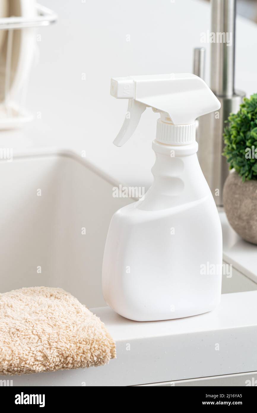 Concept of cleaning product spray bottle and rag in modern kitchen ...