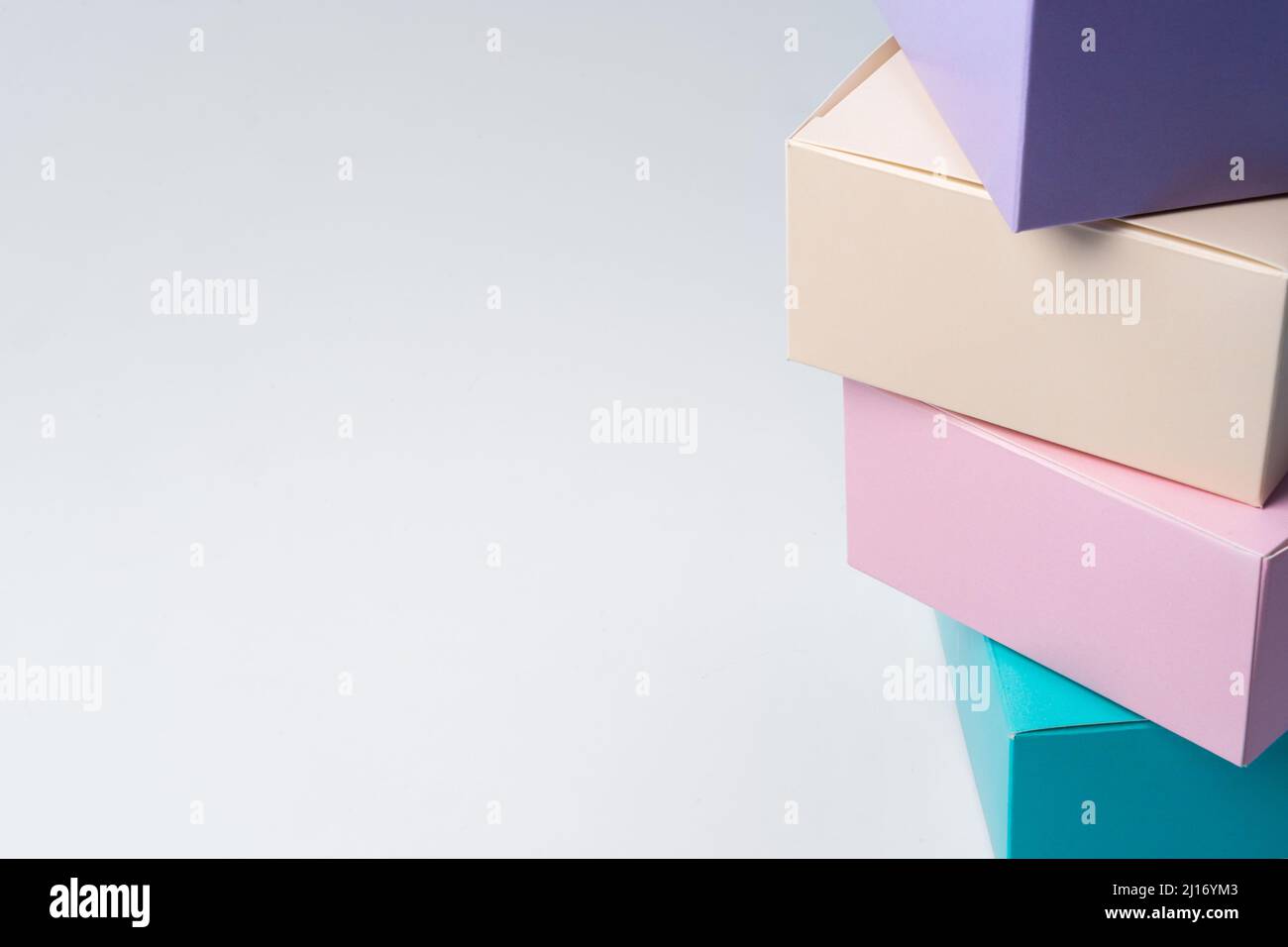 Pile of colorful cardboard boxes on white background Stock Photo - Alamy