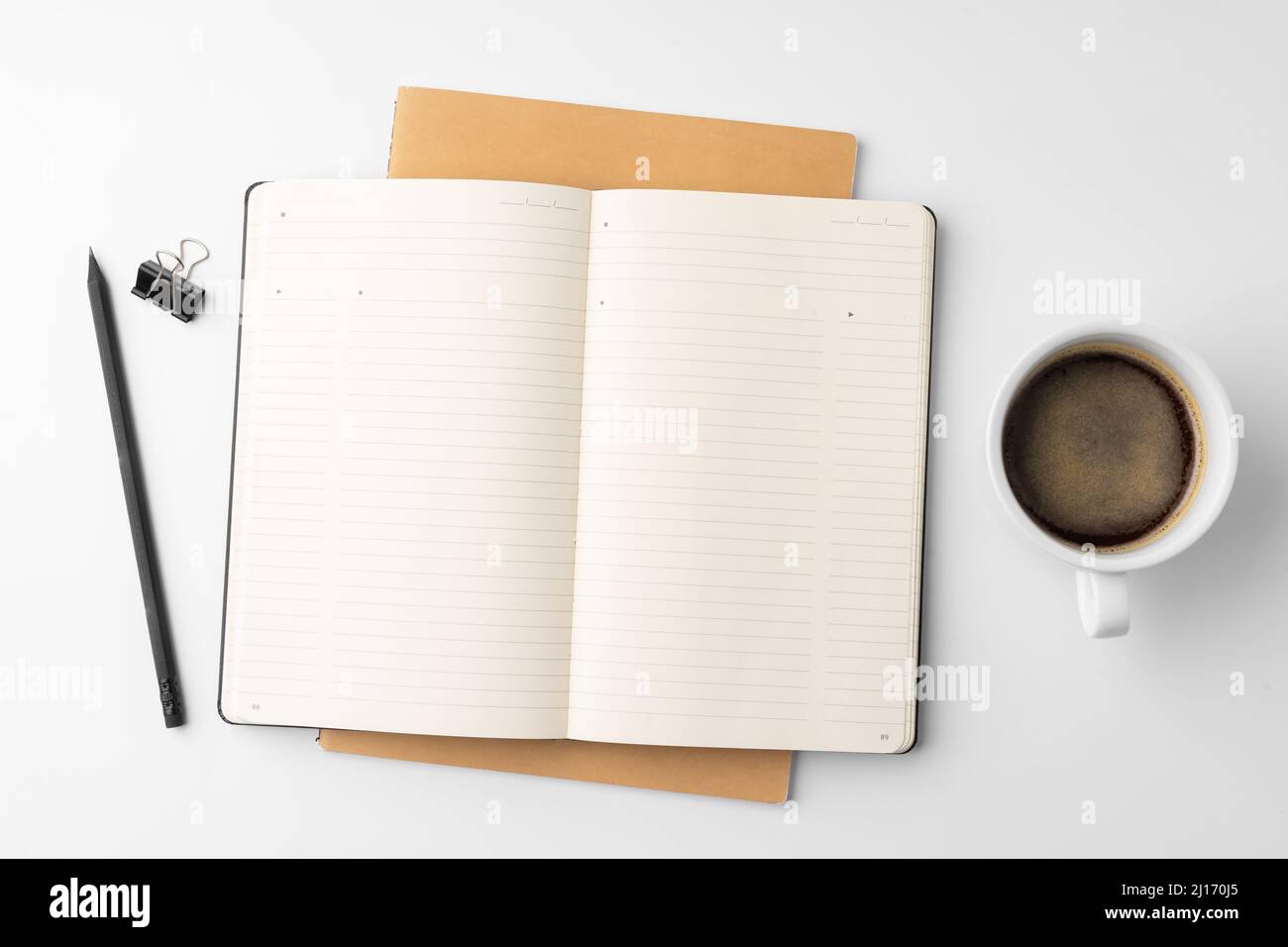 Cup of coffee and notepad on white background Stock Photo - Alamy