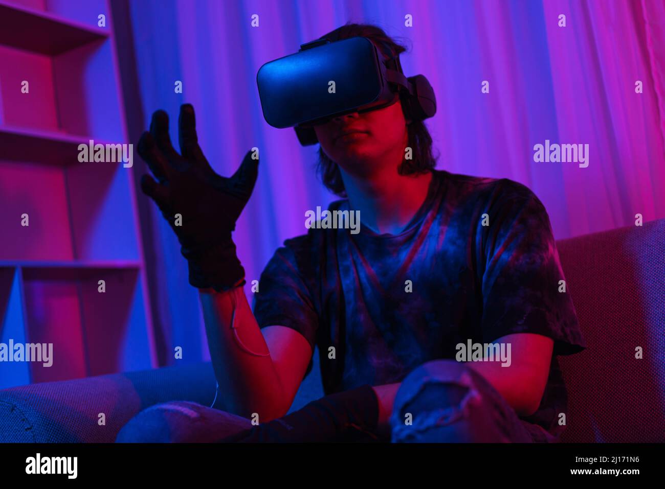 Metaverse technology concept, Man wear VR goggles and glove to making ...