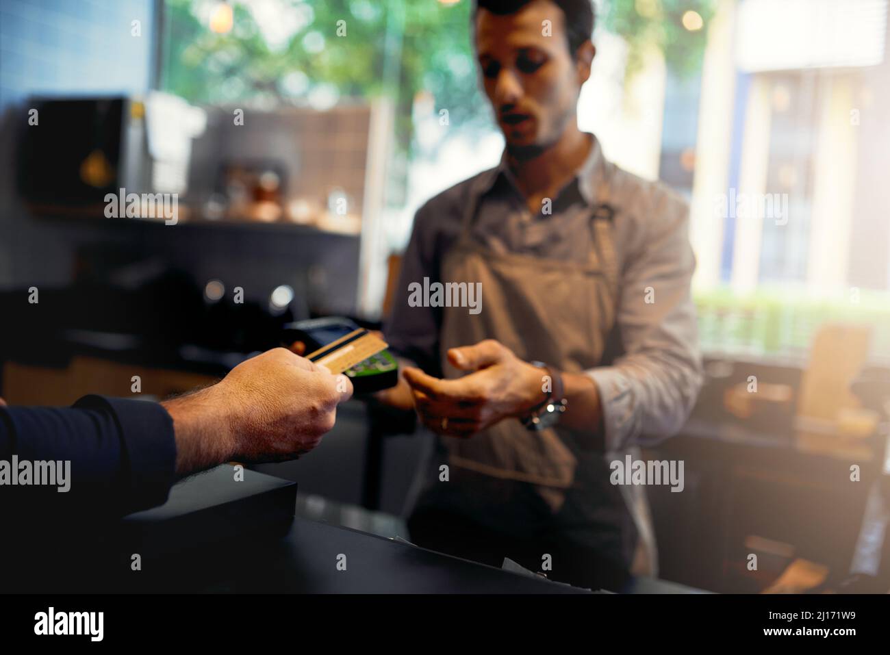 Making payment. Cropped shot of an unrecognizable male customer making ...