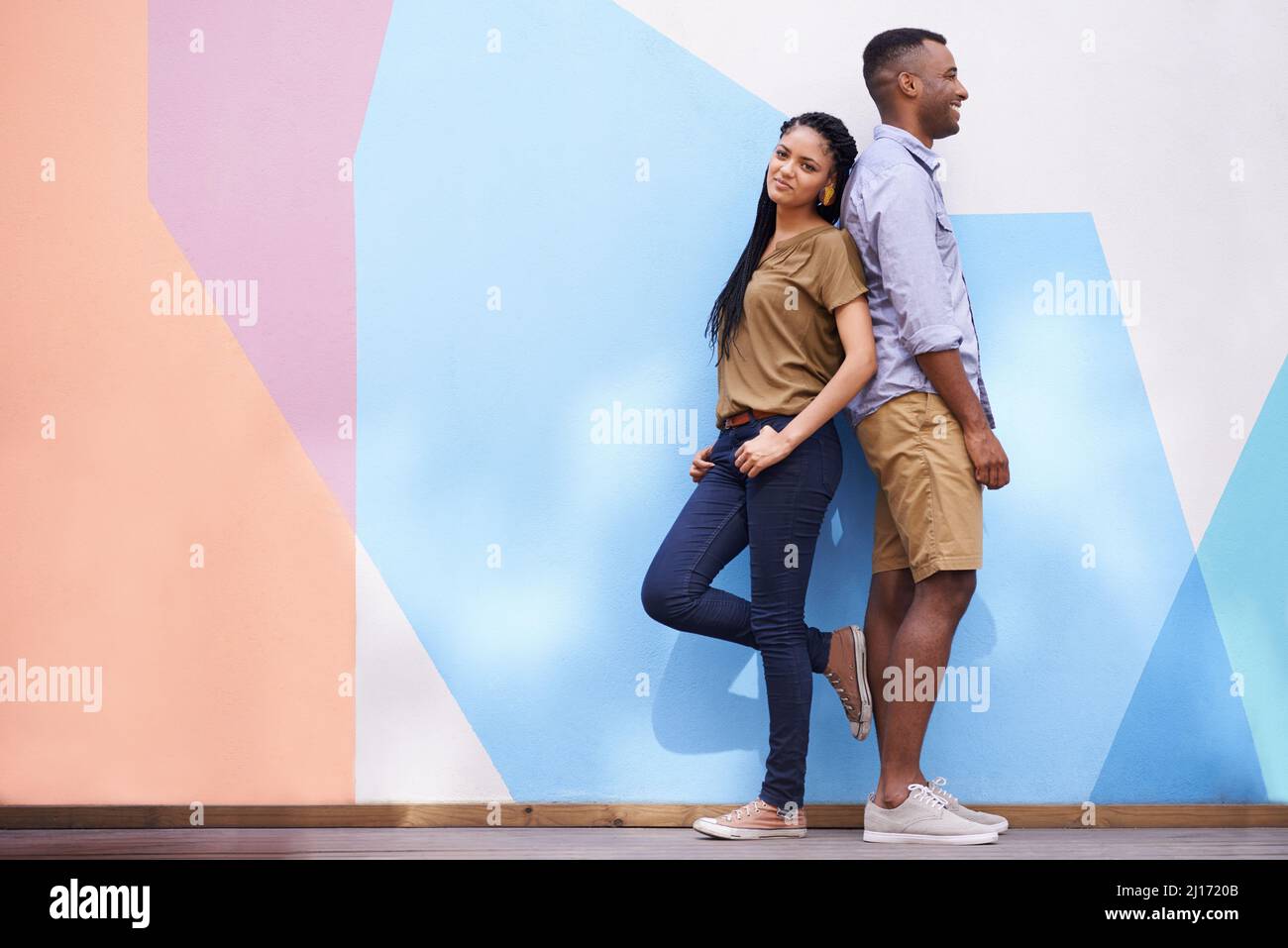 Theyve got each others back. Shot of a young couple standing back-to ...