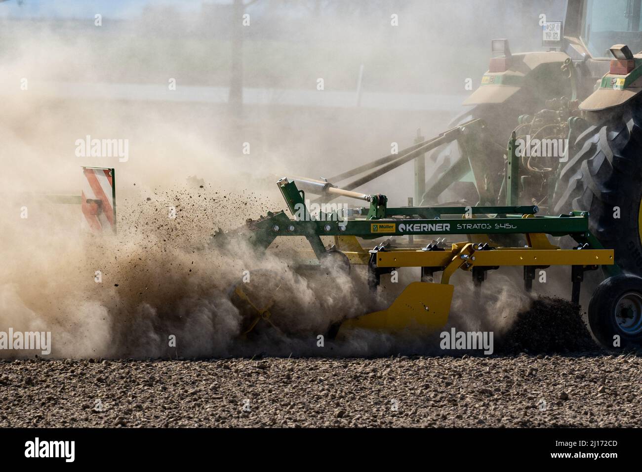 Feldkirchen, Germany. 23rd Mar, 2022. A farmer raises dust with his ...