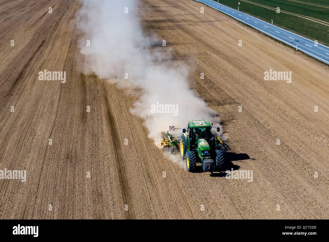 Feldkirchen, Germany. 23rd Mar, 2022. A farmer raises dust with his ...