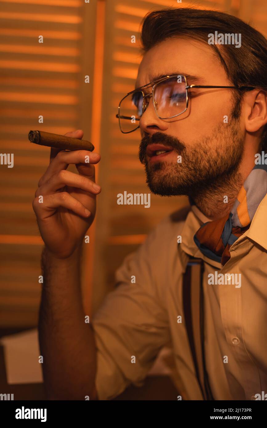 young man with mustache and eyeglasses smoking cigar Stock Photo - Alamy