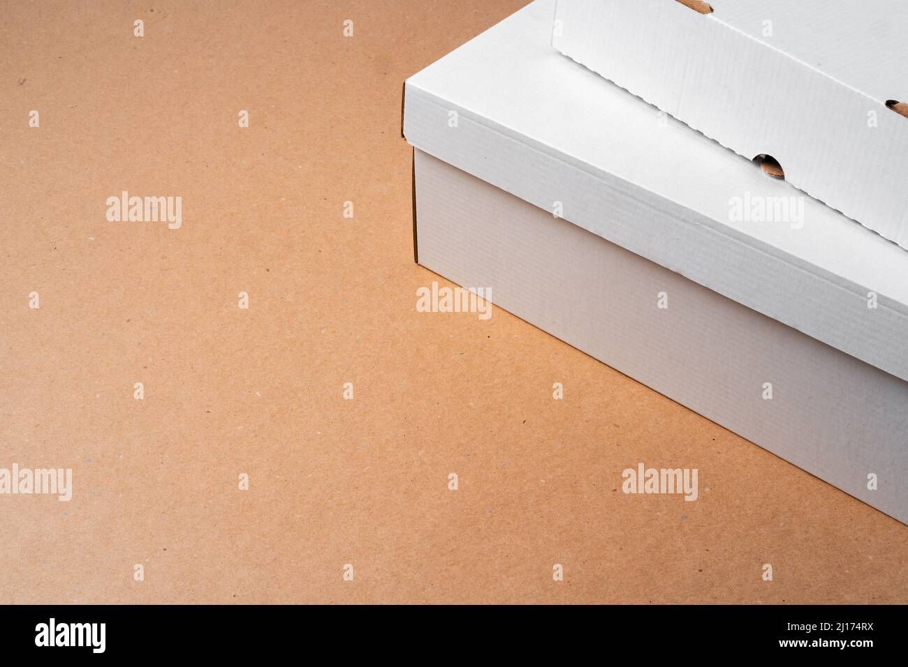 Cardboard box on beige background in studio Stock Photo - Alamy