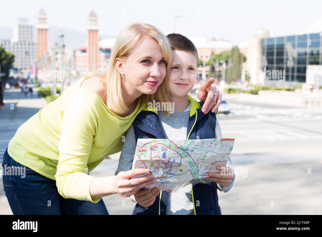 Positive mother and son reading map guide during sightseeing tour Stock ...