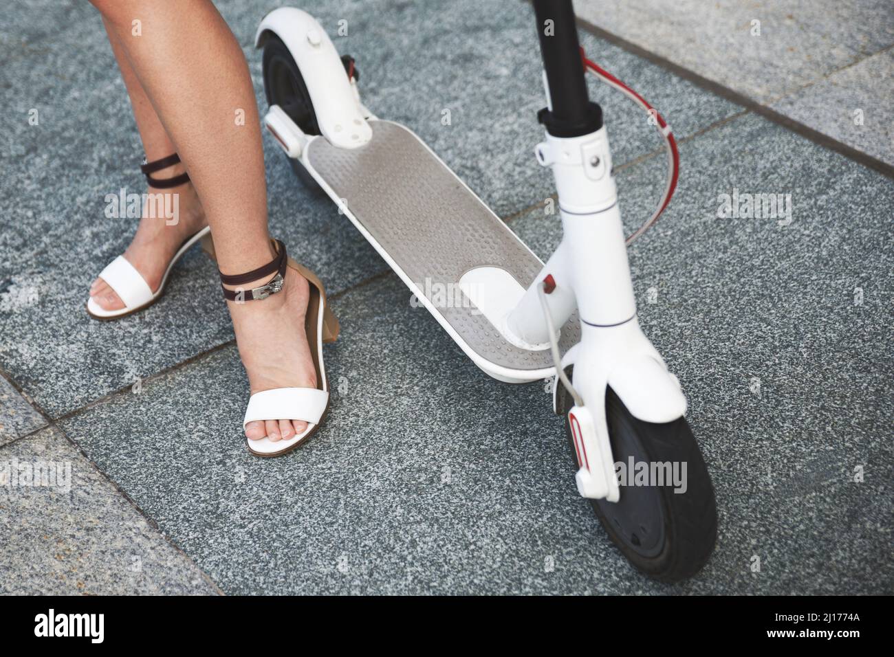 Female legs on the modern electric scooter Stock Photo - Alamy