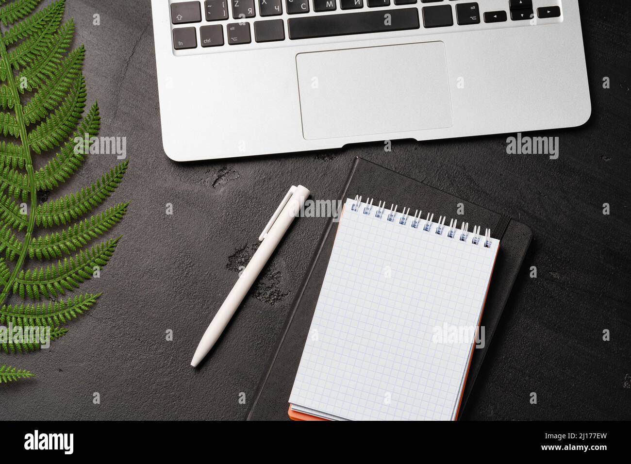 Notepad is on top of office desk table with laptop and supplies Stock ...