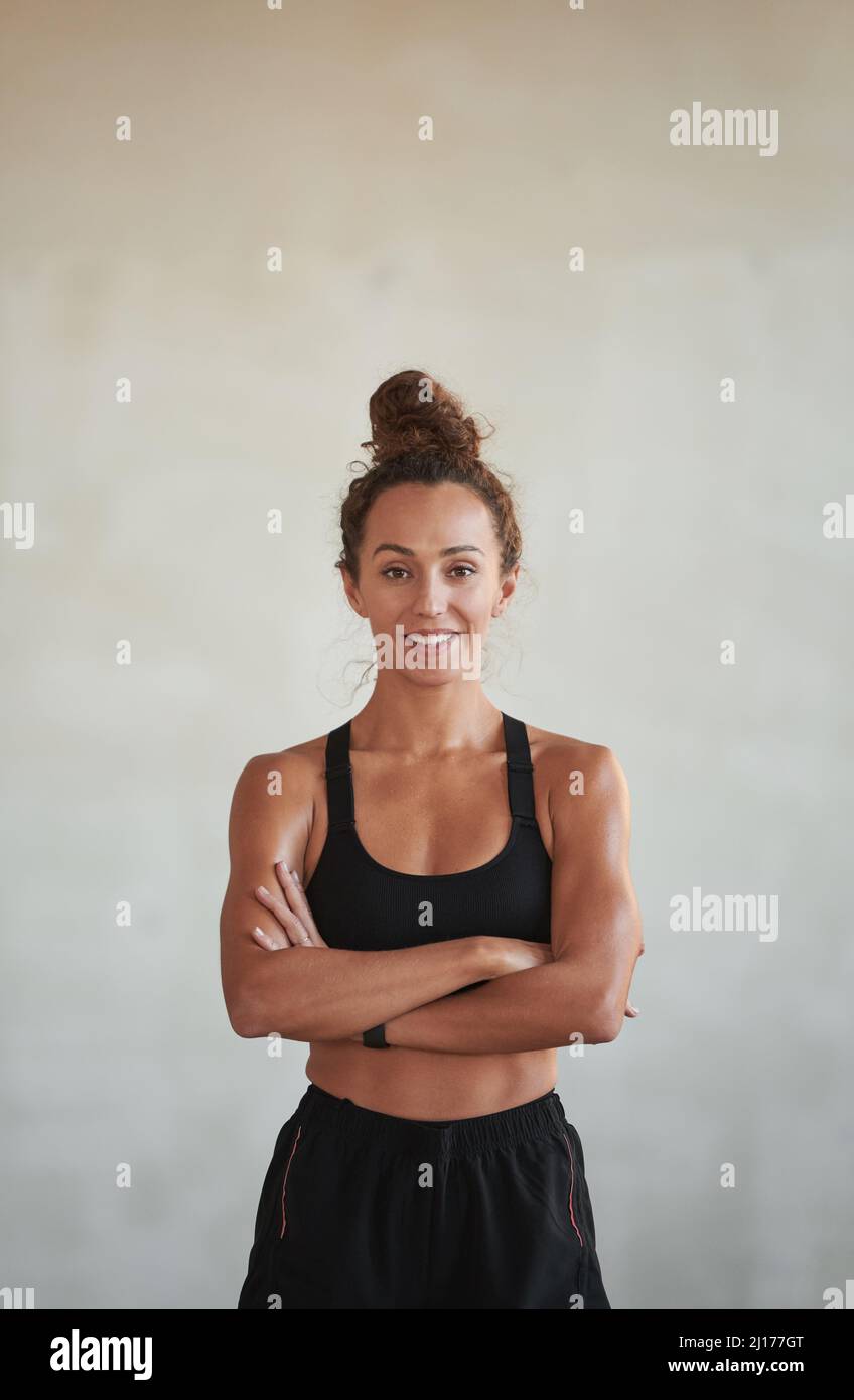 Vertical medium portrait of young adult Caucasian woman with muscular ...