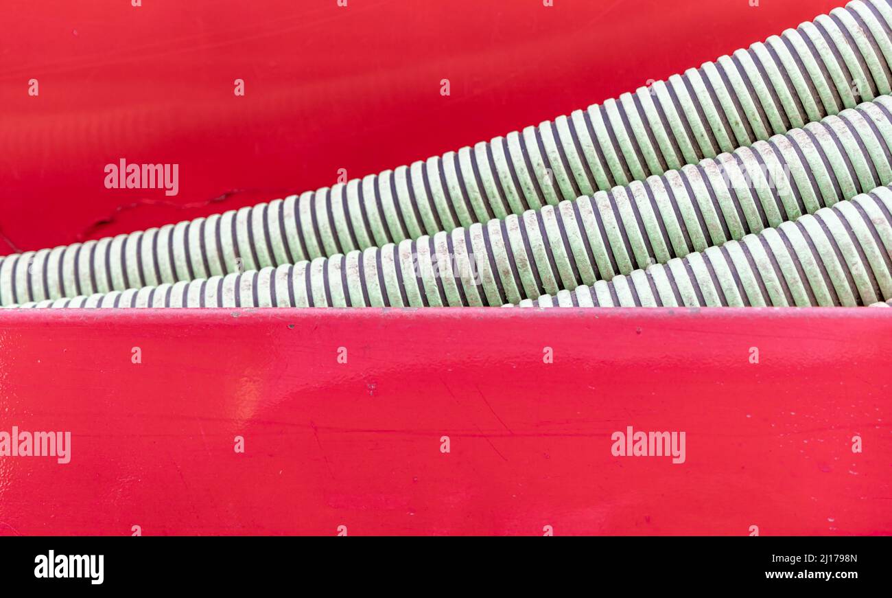 ribbed hoses in a red background Stock Photo - Alamy