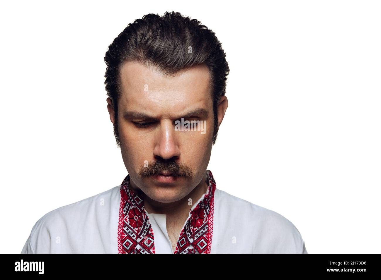 Portrait of sad concentrated man with moustache looking down, wearing ...