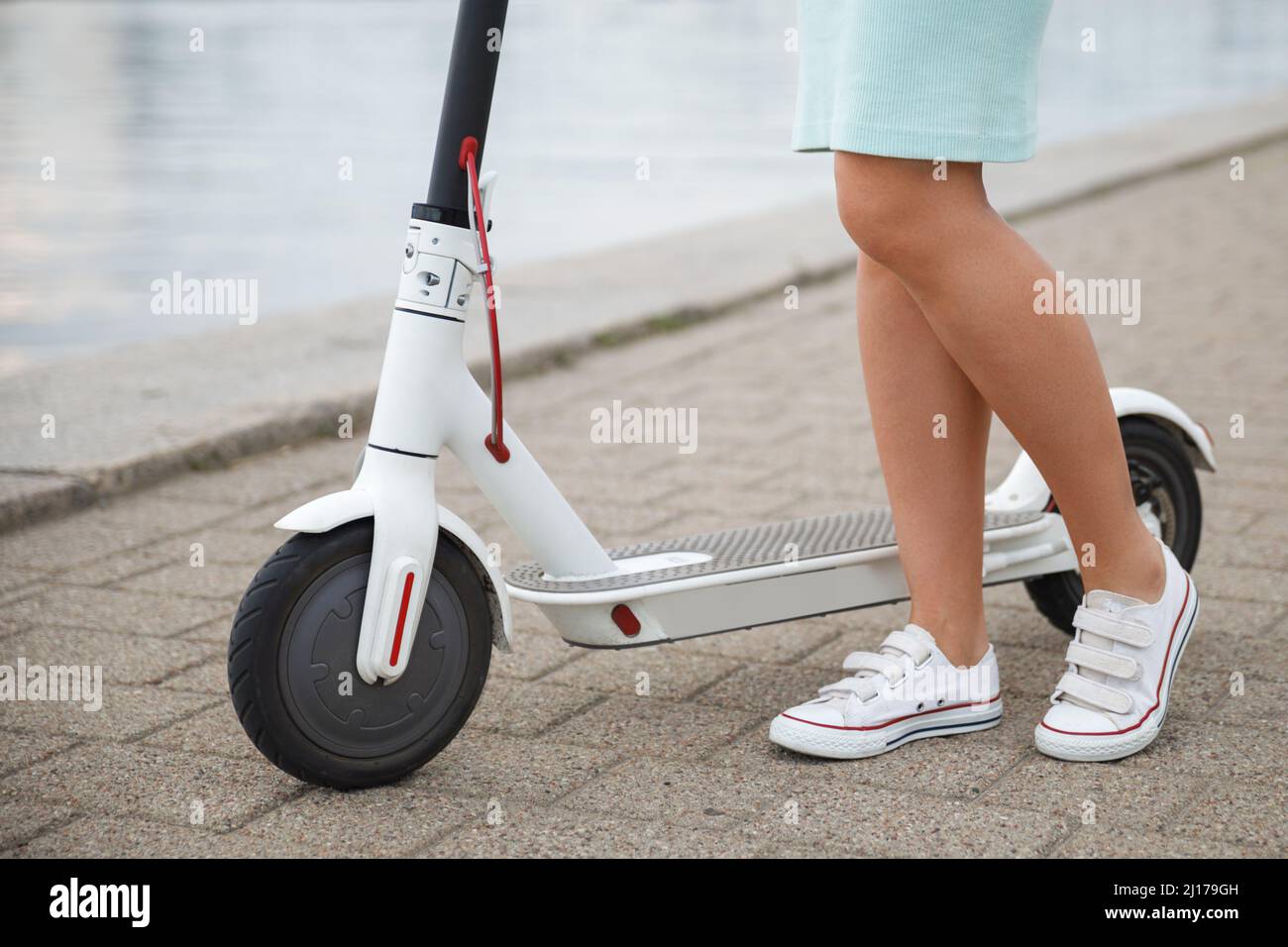 Female legs on the electric scooter Stock Photo - Alamy