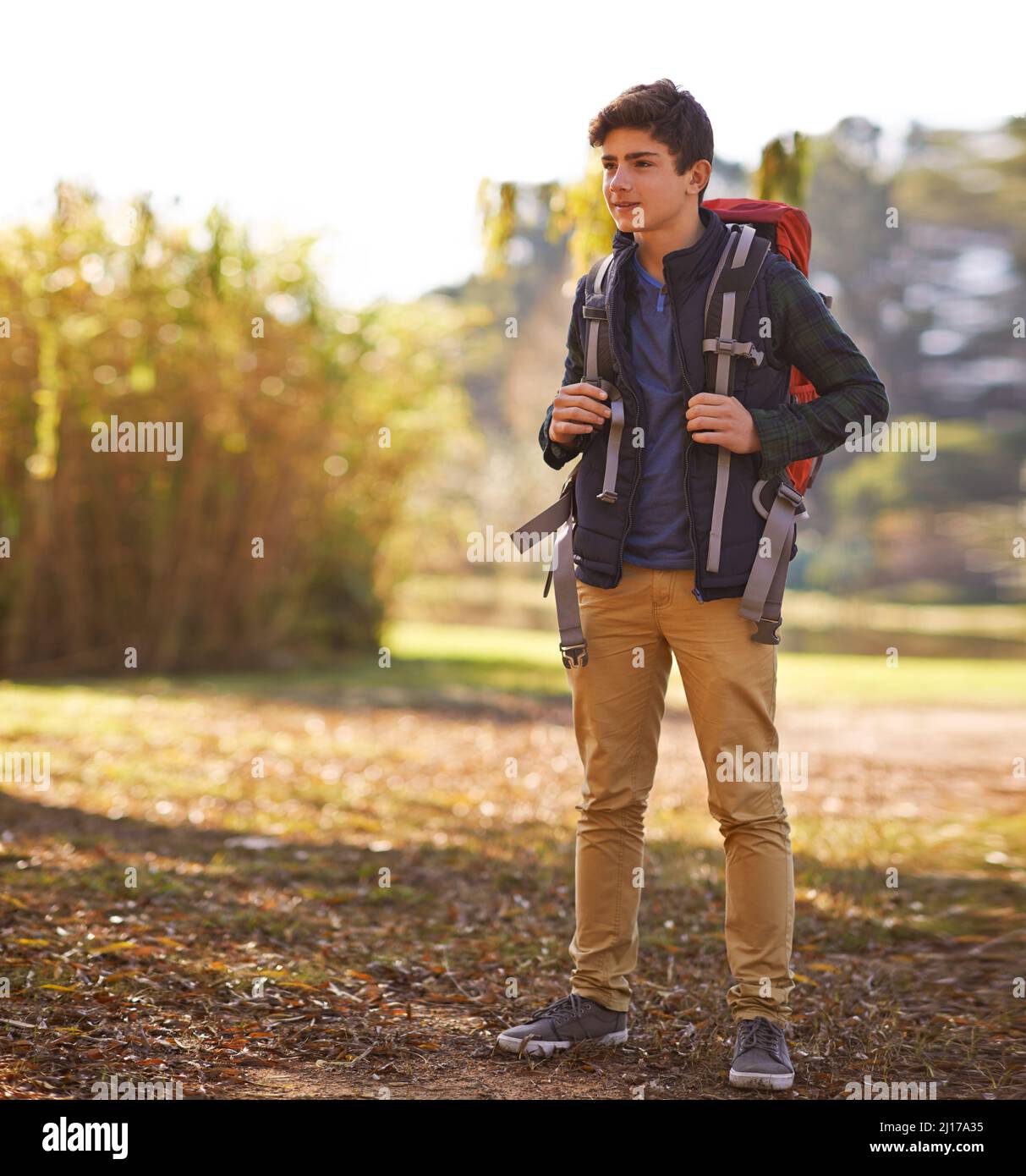 On an adventure. Shot of a young boy wearing a backpack in nature Stock ...