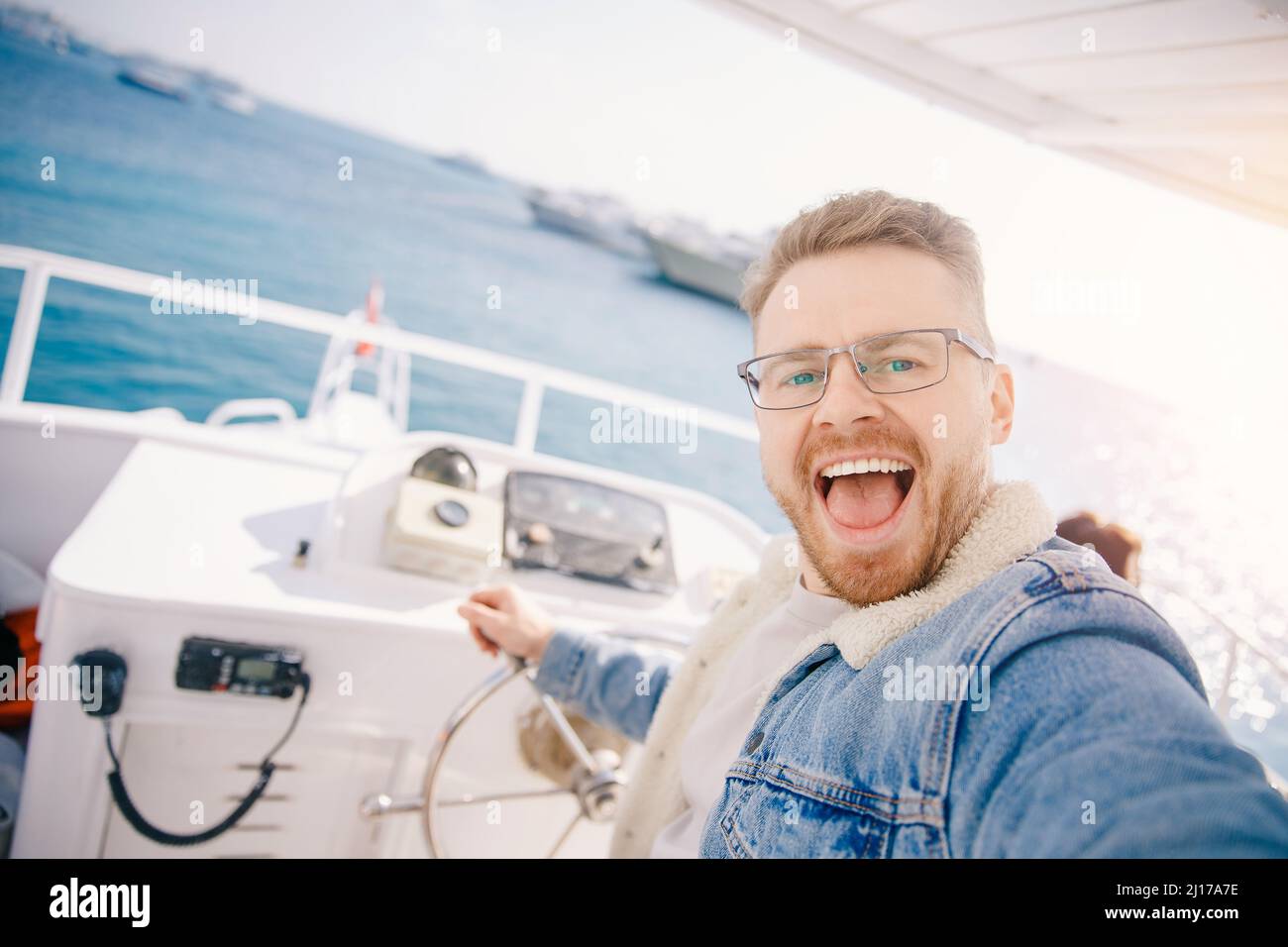 Skipper yacht takes wheel hi-res stock photography and images - Alamy