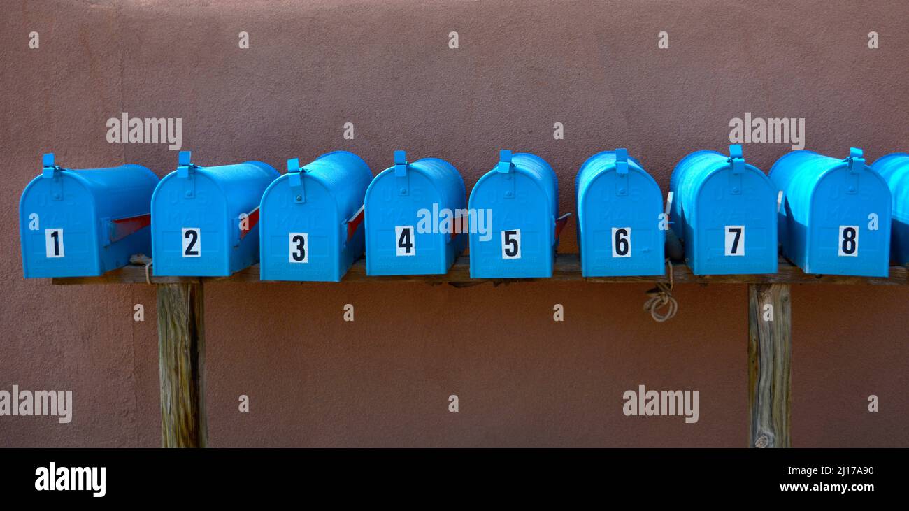 A row of blue mailboxes in front of a condominium complex in Santa Fe ...