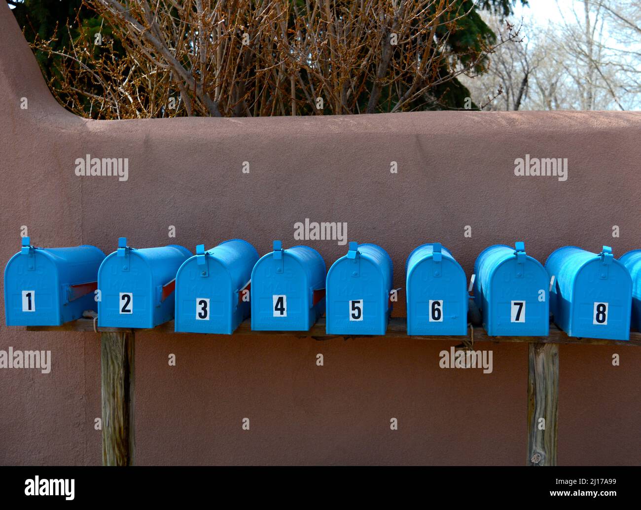 A row of blue mailboxes in front of a condominium complex in Santa Fe ...