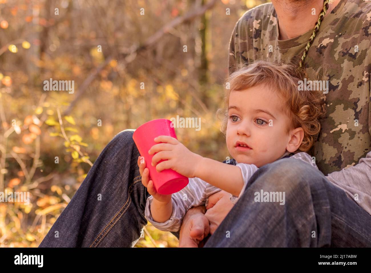 father and son in nature on a sunny warm day have happiness Stock Photo ...