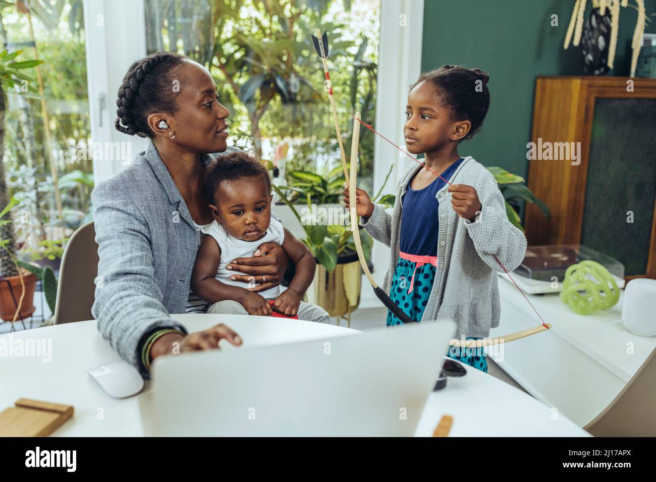 Mother talking to daughter and working at home Stock Photo - Alamy