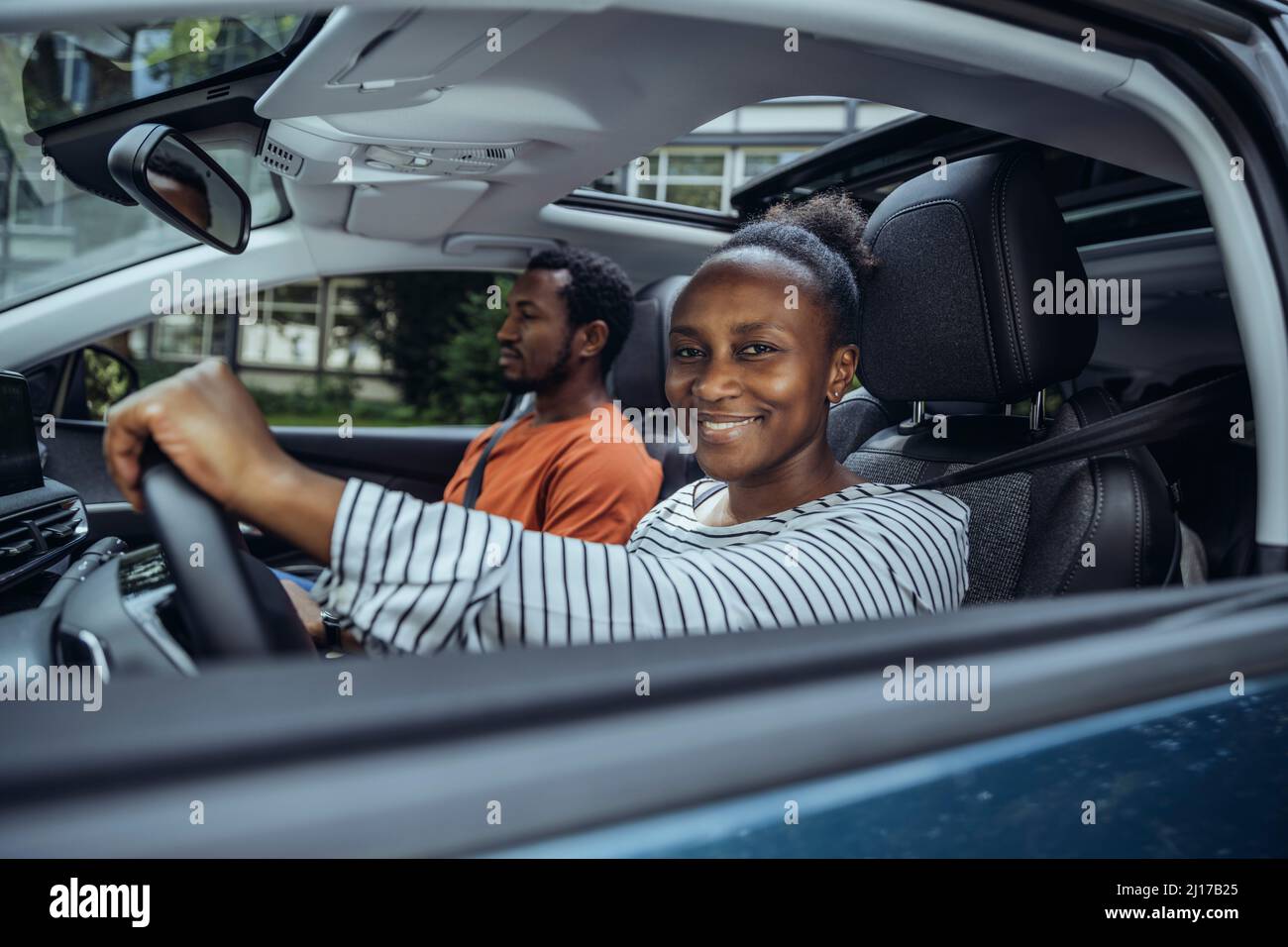 Woman driving car with man on road trip Stock Photo - Alamy